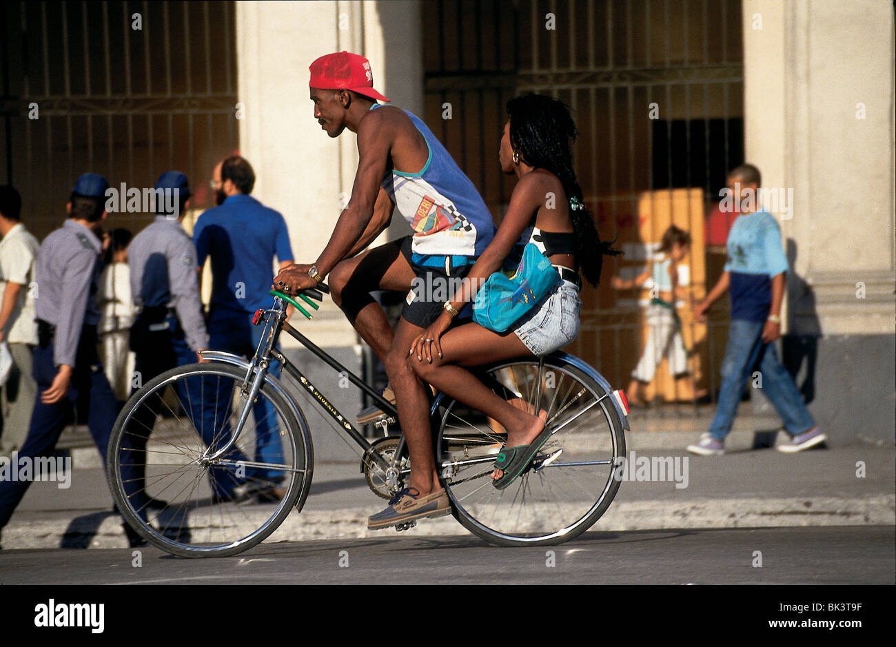 Two people riding a bicycle in the street of Havana, Cuba Stock Photo ...