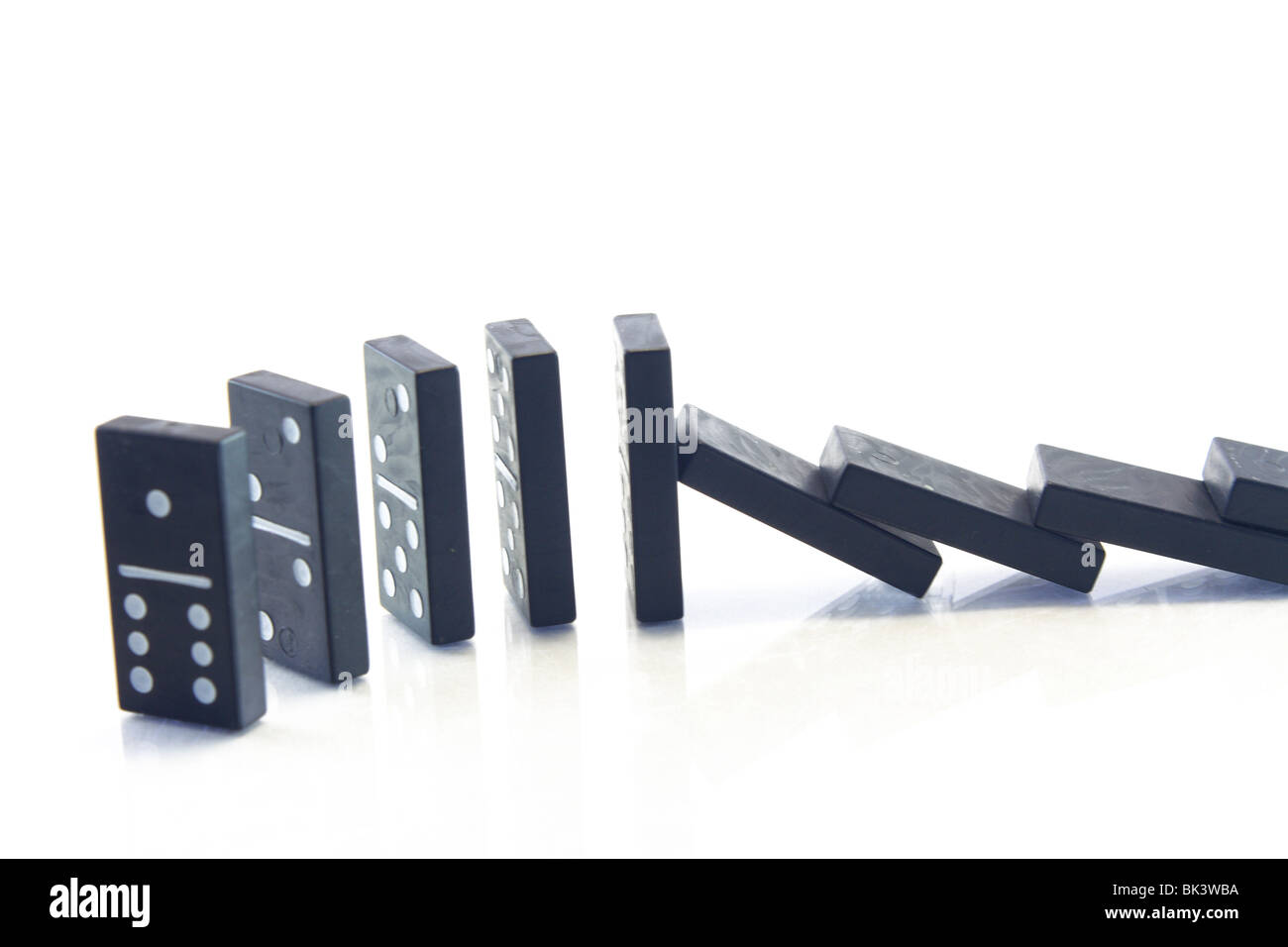 chains of falling domino isolated on a white background Stock Photo - Alamy