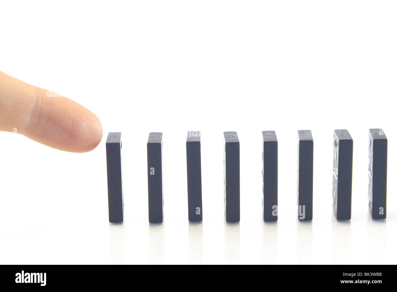 start reaction with pushing first domino Stock Photo - Alamy