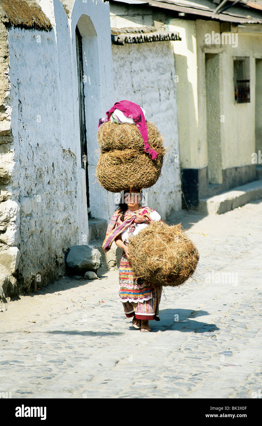 Guatemala woman carrying materials on her head, Cantel, Guatemala Stock ...
