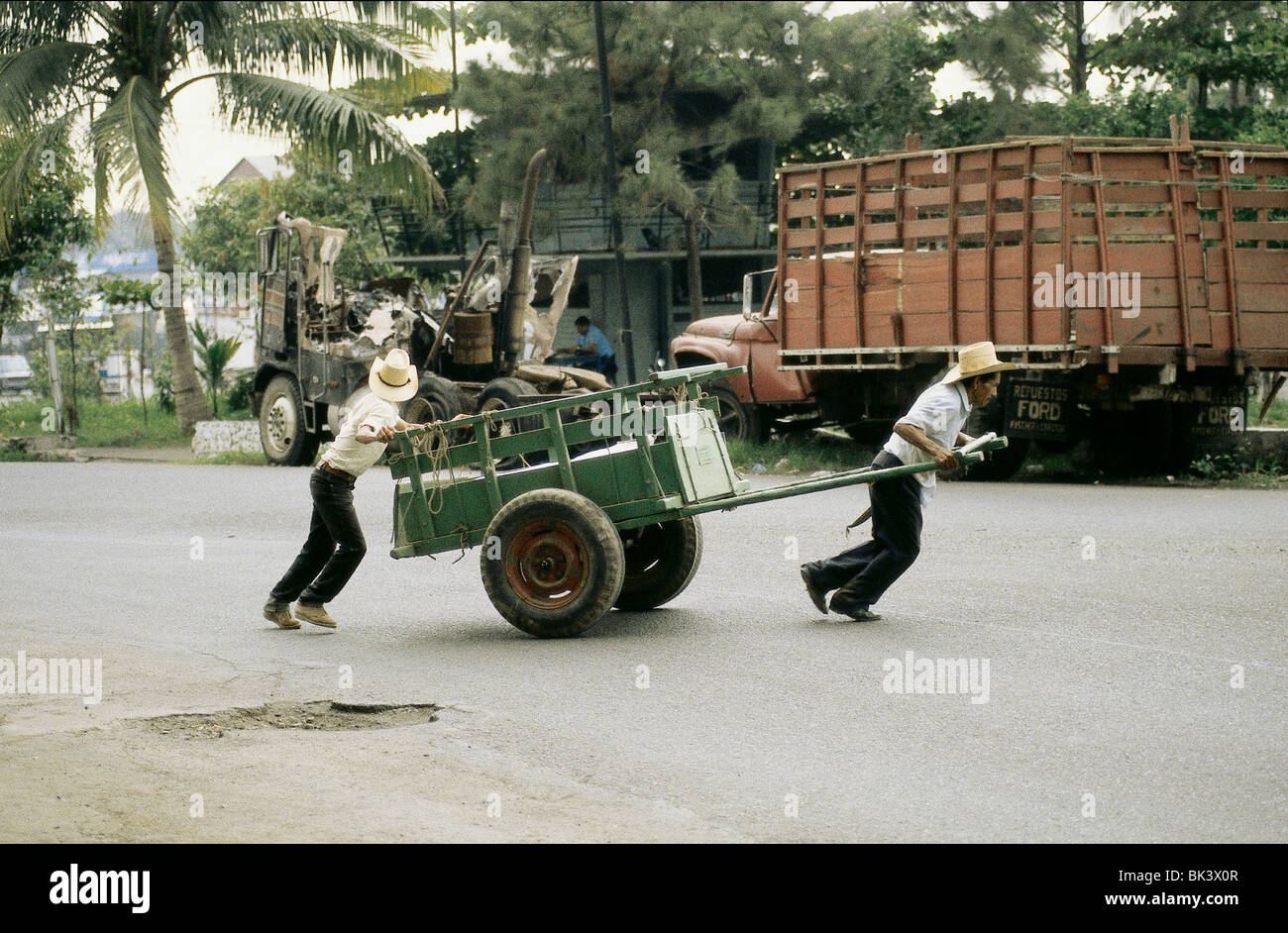 Men pushing and pulling a cart in Antigua, Guatemala, Central America ...