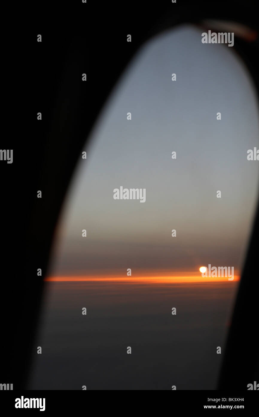 View of sunrise in flight from an airliner window Stock Photo - Alamy