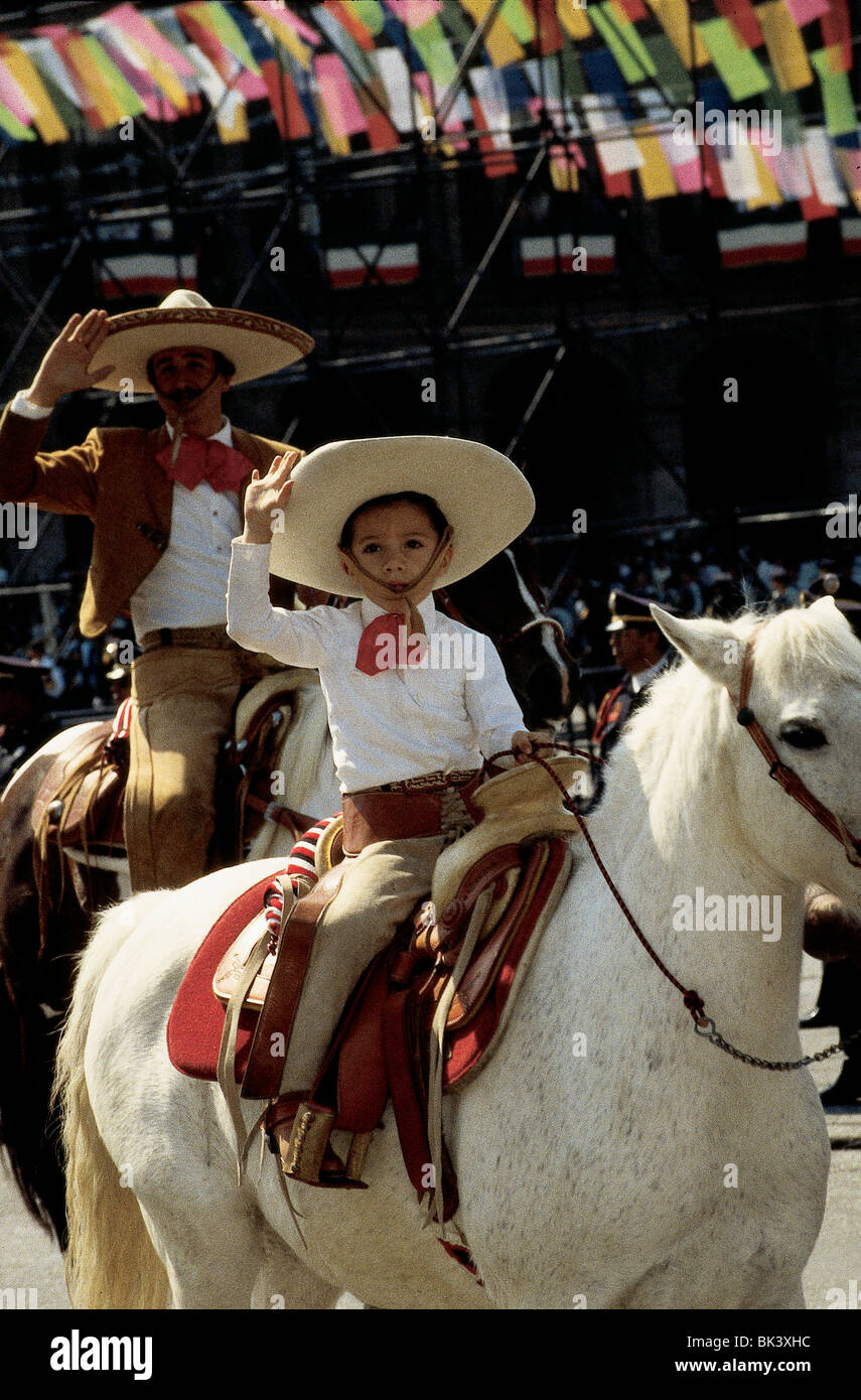 Adult male and boy on horseback, Mexico City Parade, Mexico Stock Photo ...