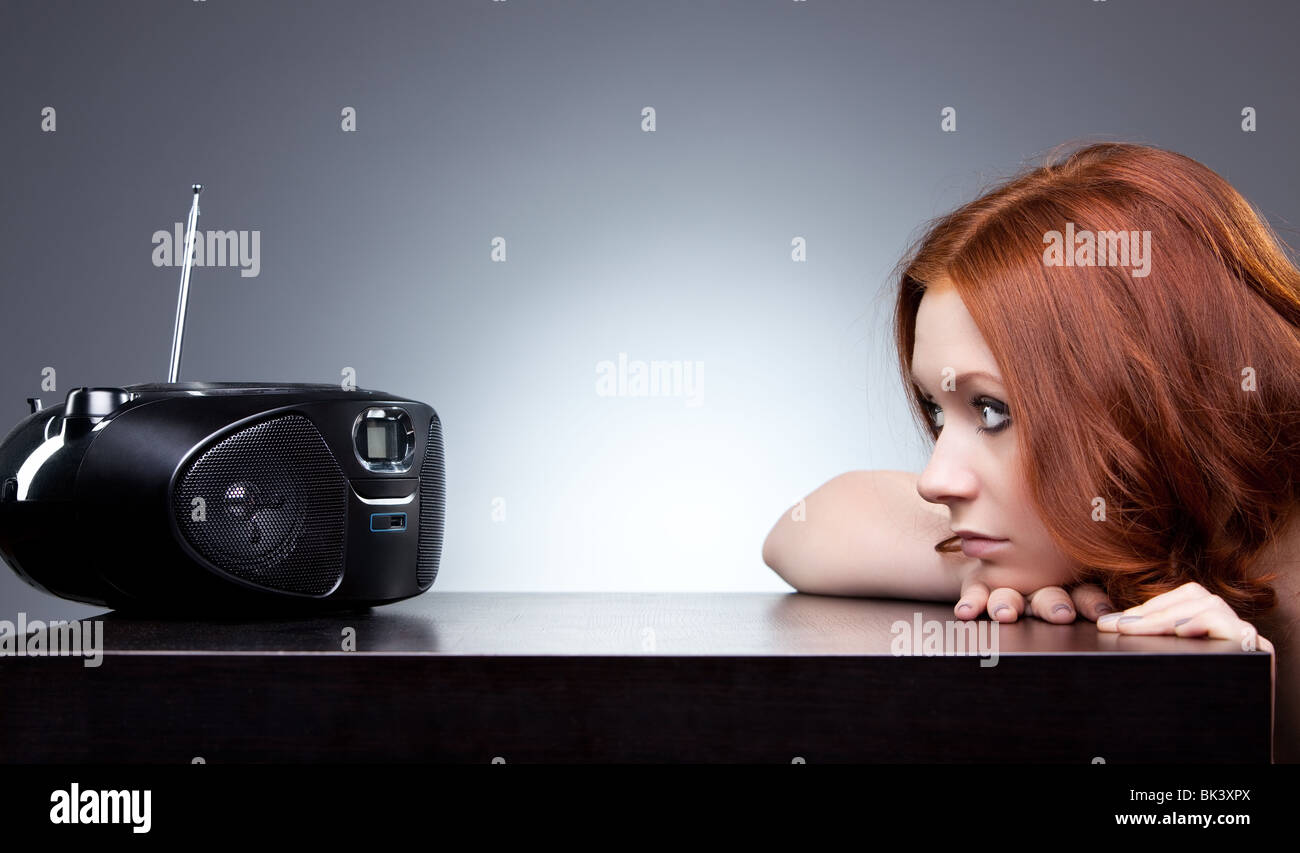 Young woman listening radio. Boring mood Stock Photo - Alamy