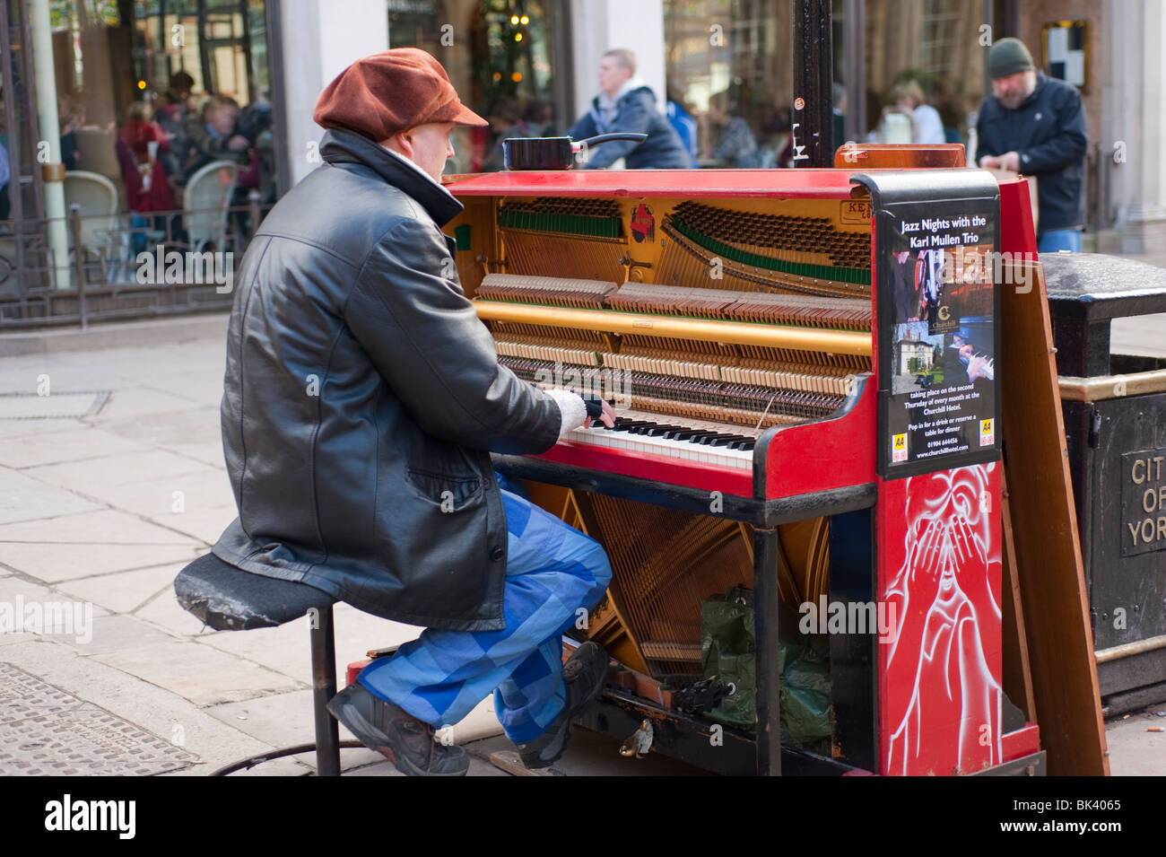 Street entertainer playing upright piano in public shopping area Stock ...