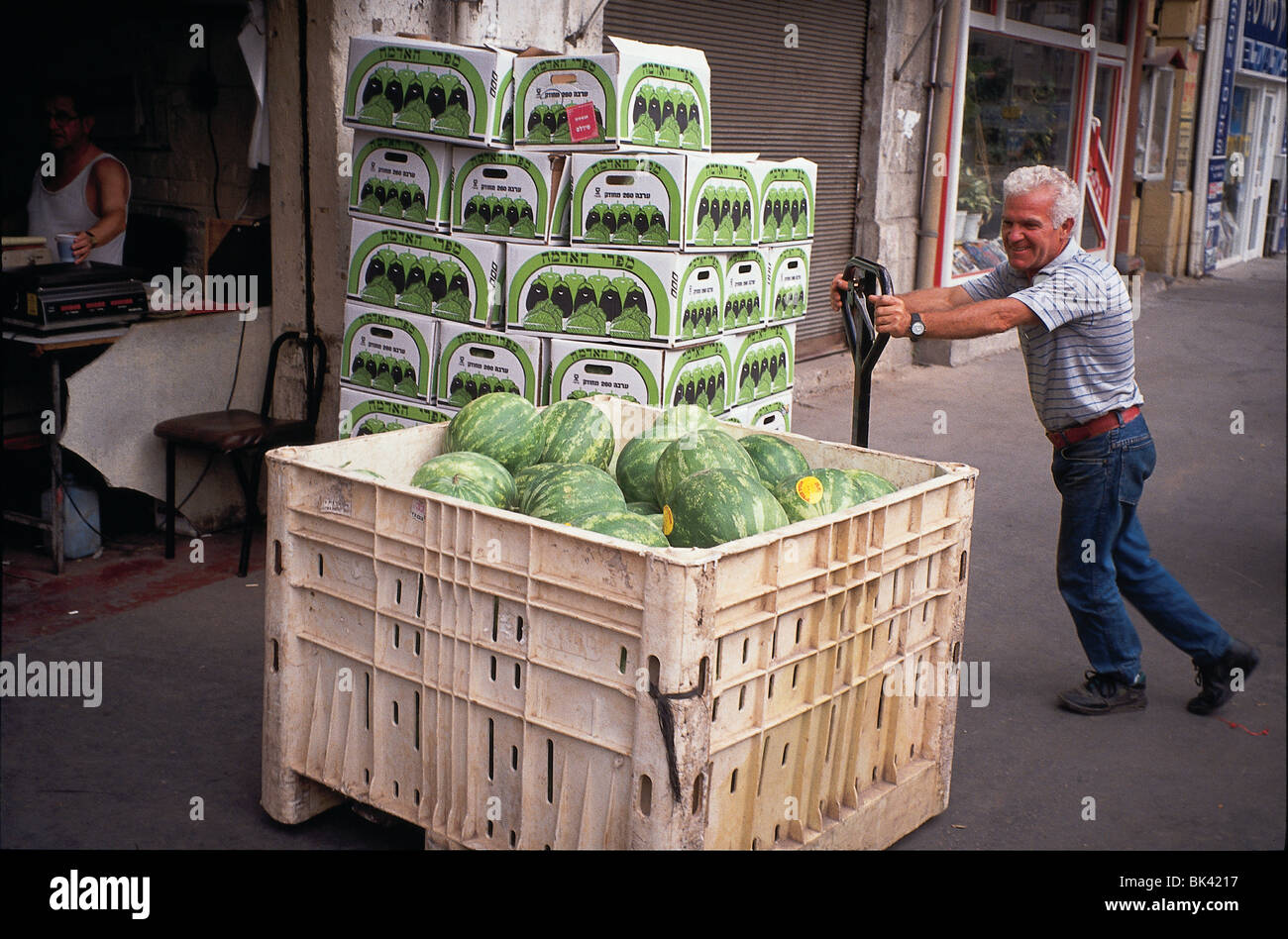 Grocer pushing a crate of melons in Tiberias, Israel Stock Photo - Alamy