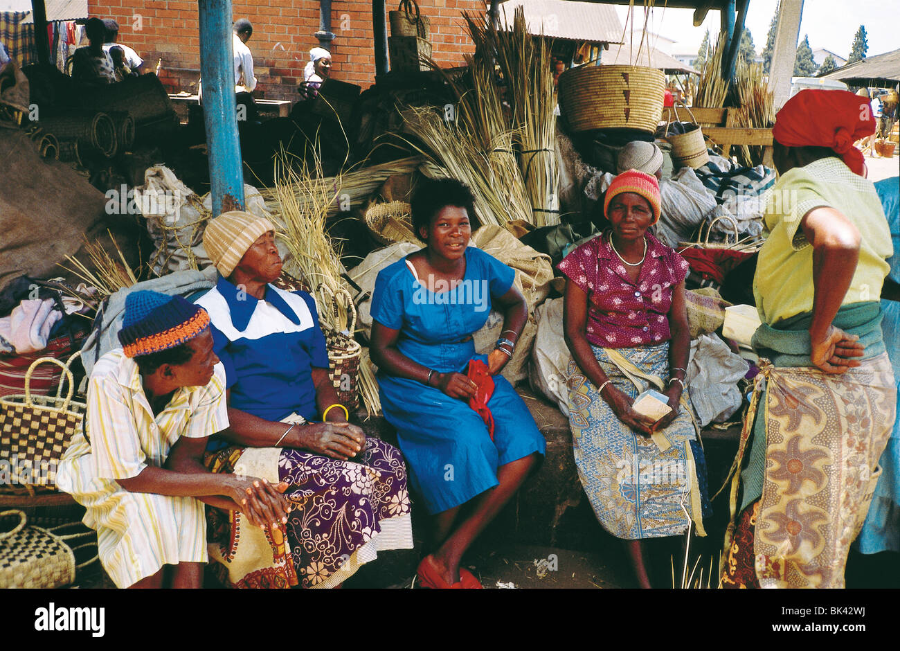 Women in a marketplace with woven baskets in Harare, Zimbabwe Stock ...