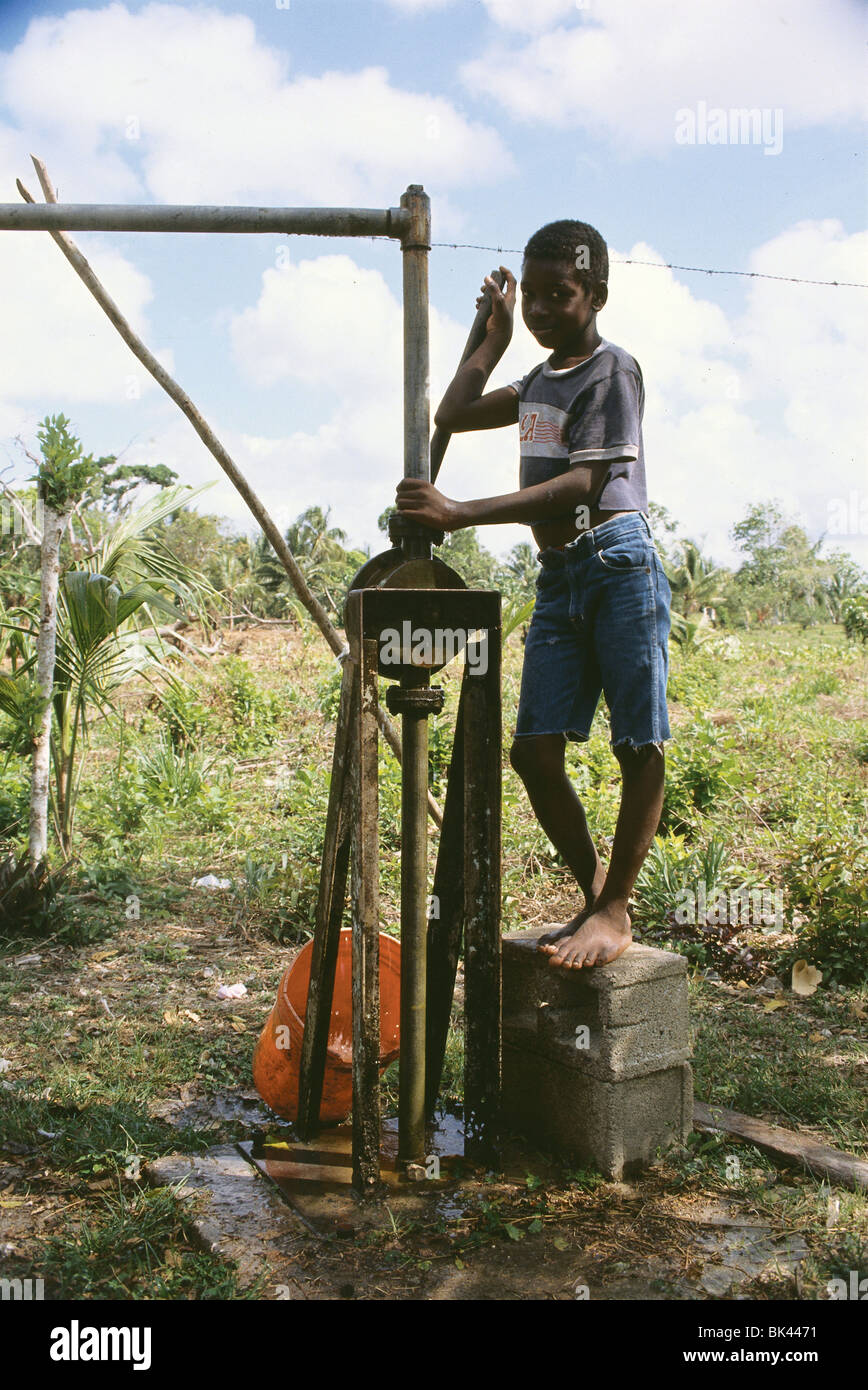 Boy pumping water from well in Belize, Central America Stock Photo - Alamy