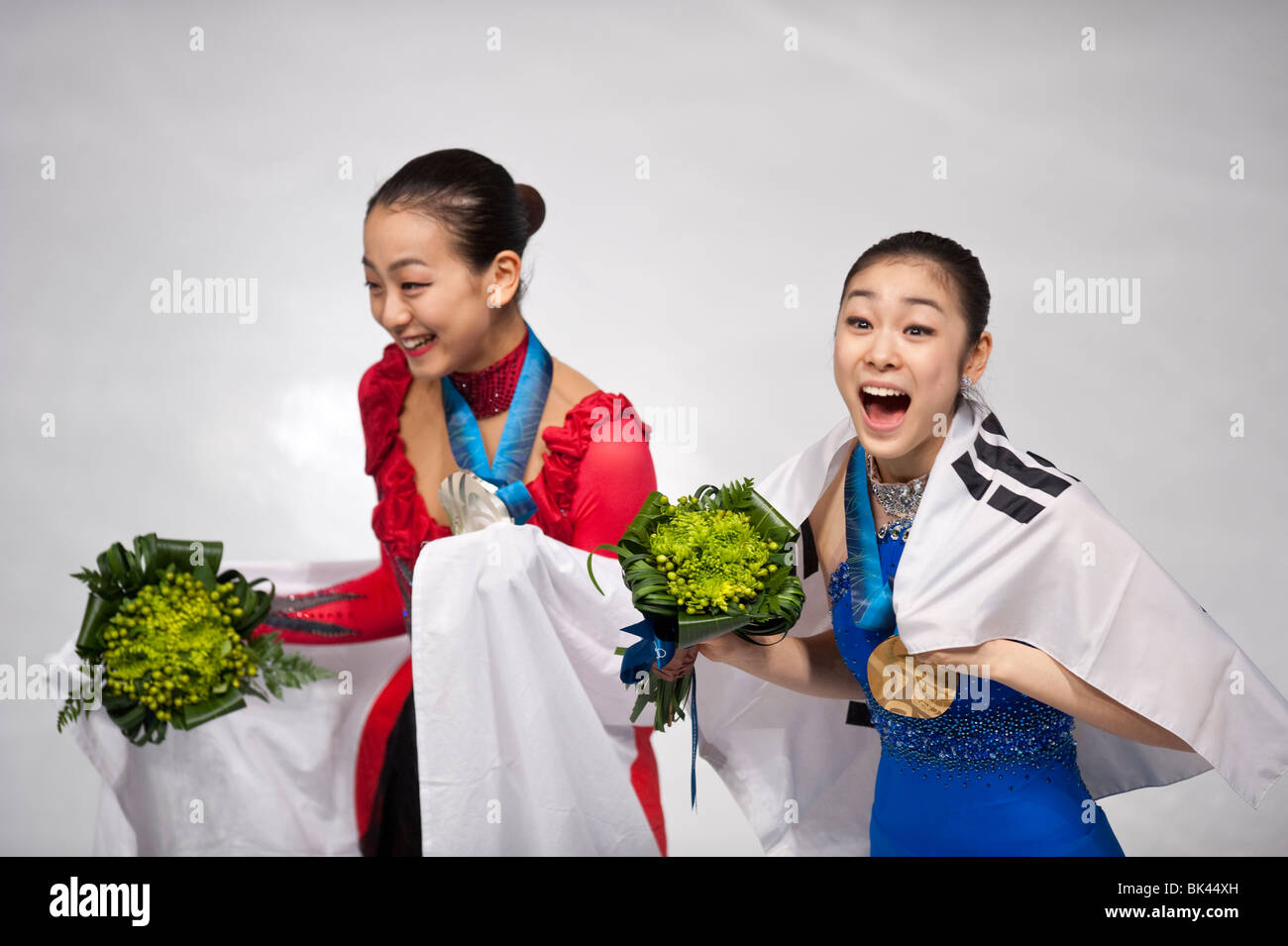 Kim Yu-Na (KOR) and Mao Asada (JPN)wrapped in their country"s flags ...