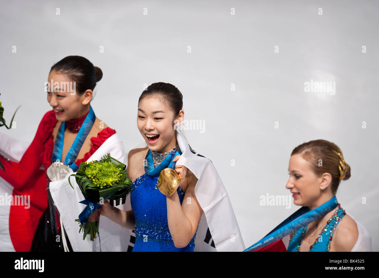 Kim Yu-Na (KOR), Mao Asada (JPN) and Joannie Rochette (CAN) wrapped in ...