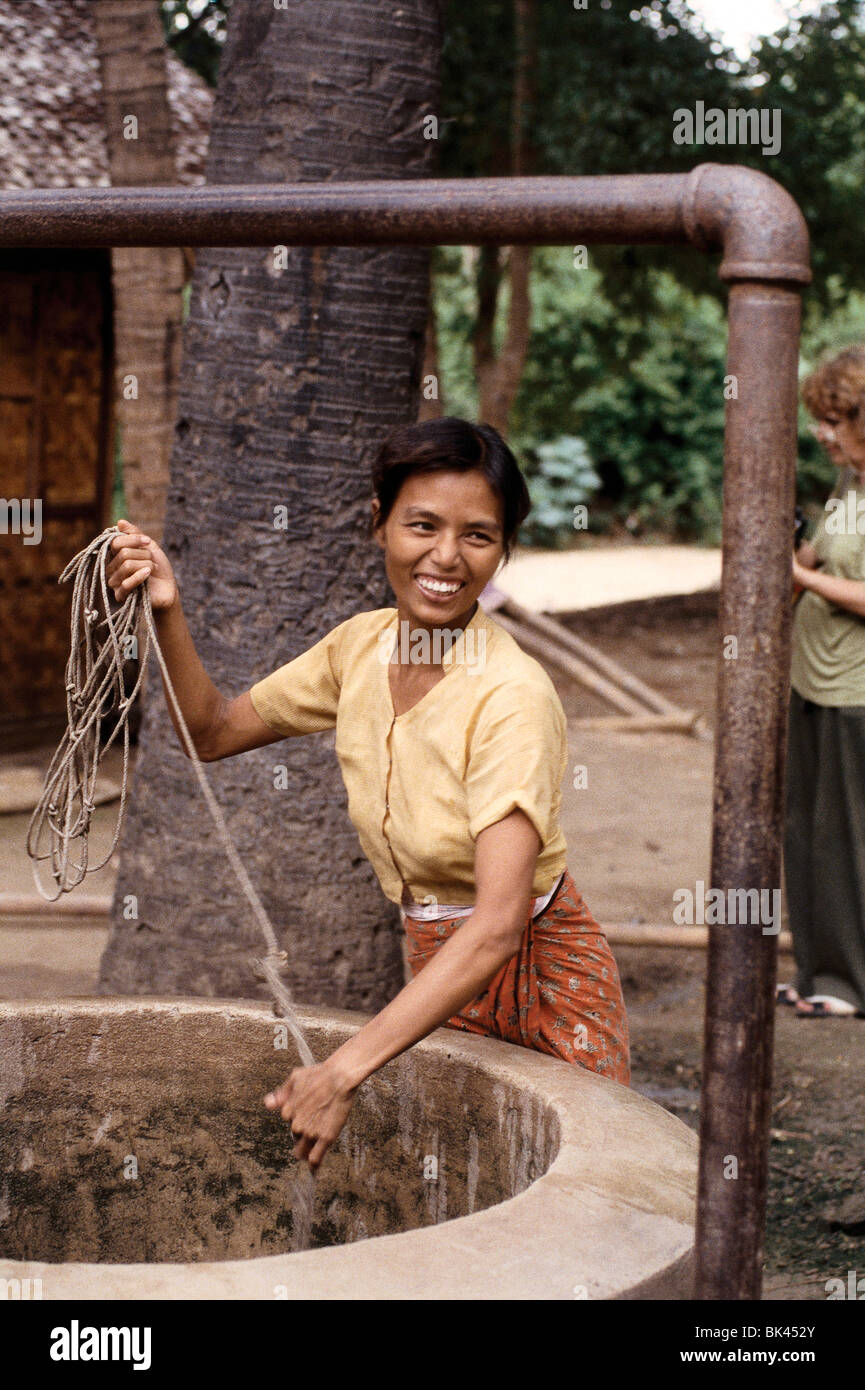 Woman at water well, Myanmar Stock Photo - Alamy