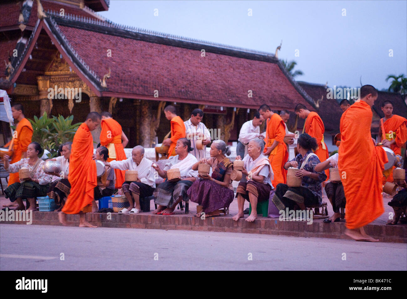 Monks rice offer at dawn, close to the Mai temple, Luang Prabang, Laos ...