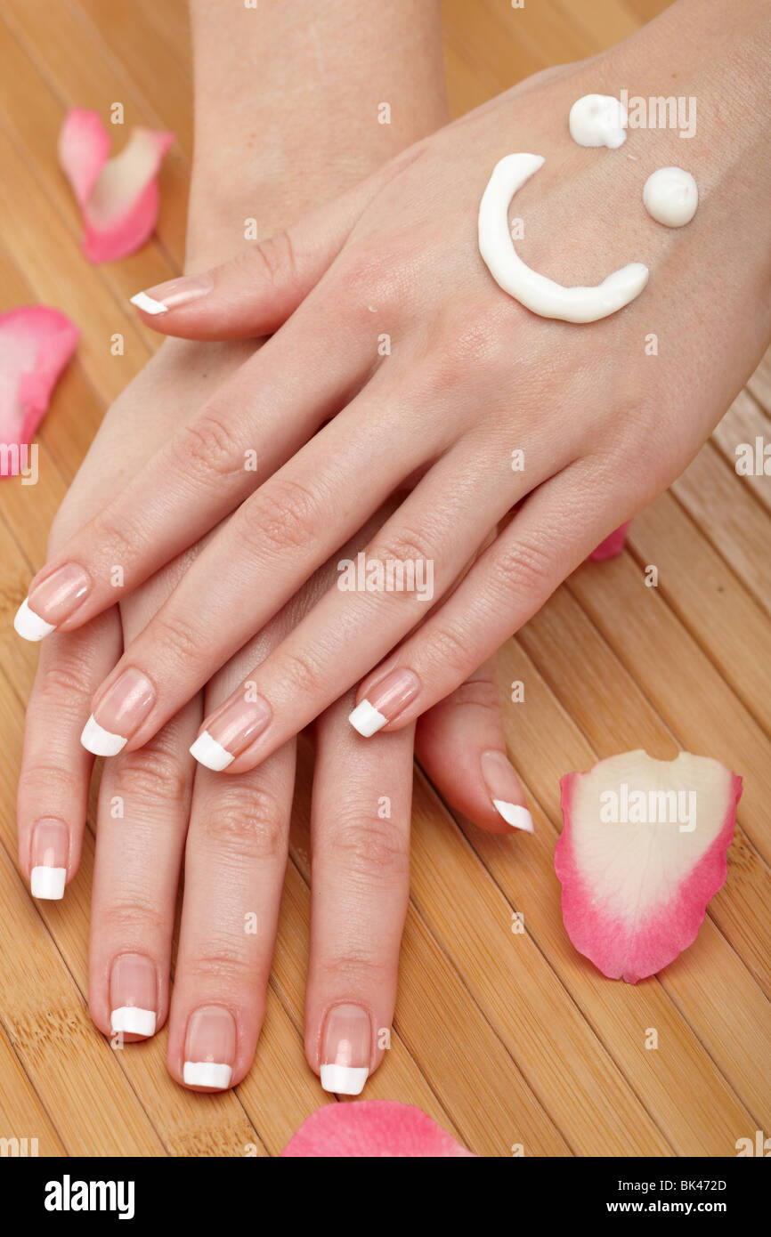 Spa hands over bamboo mat Stock Photo - Alamy