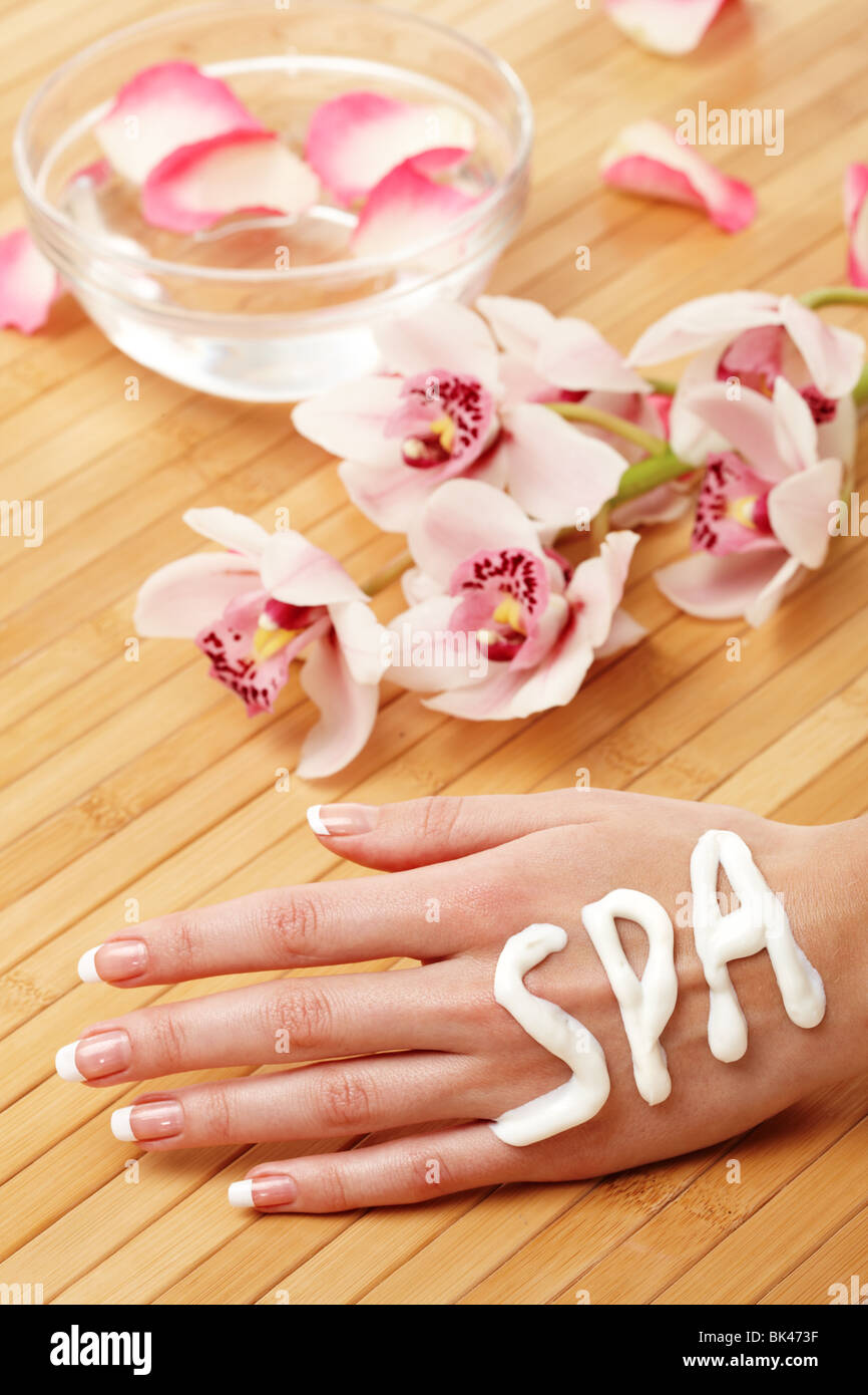 Spa hands over bamboo mat Stock Photo - Alamy