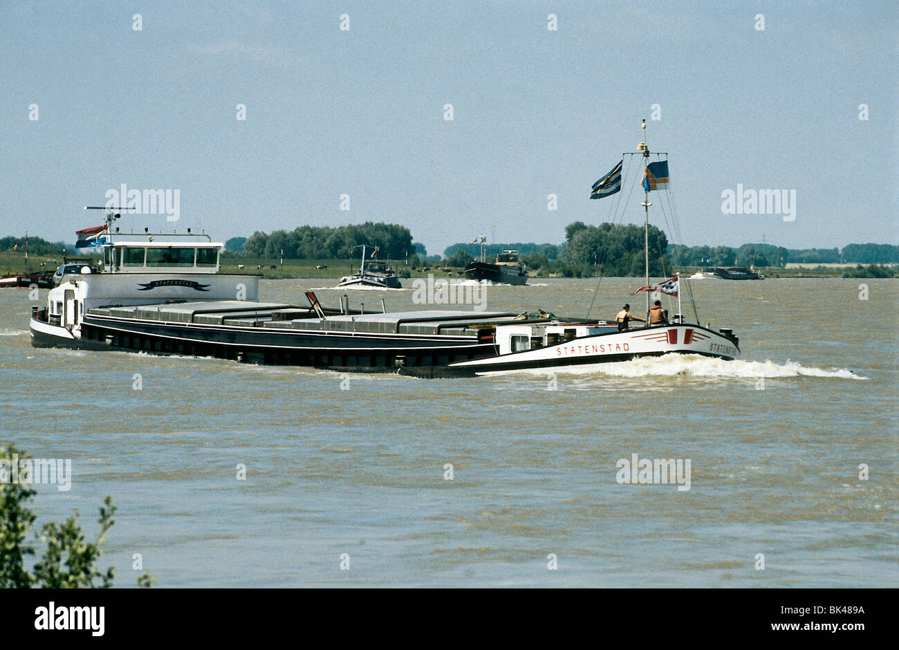 Inland motor freighter Statenstad leading a convoy of barges on the ...