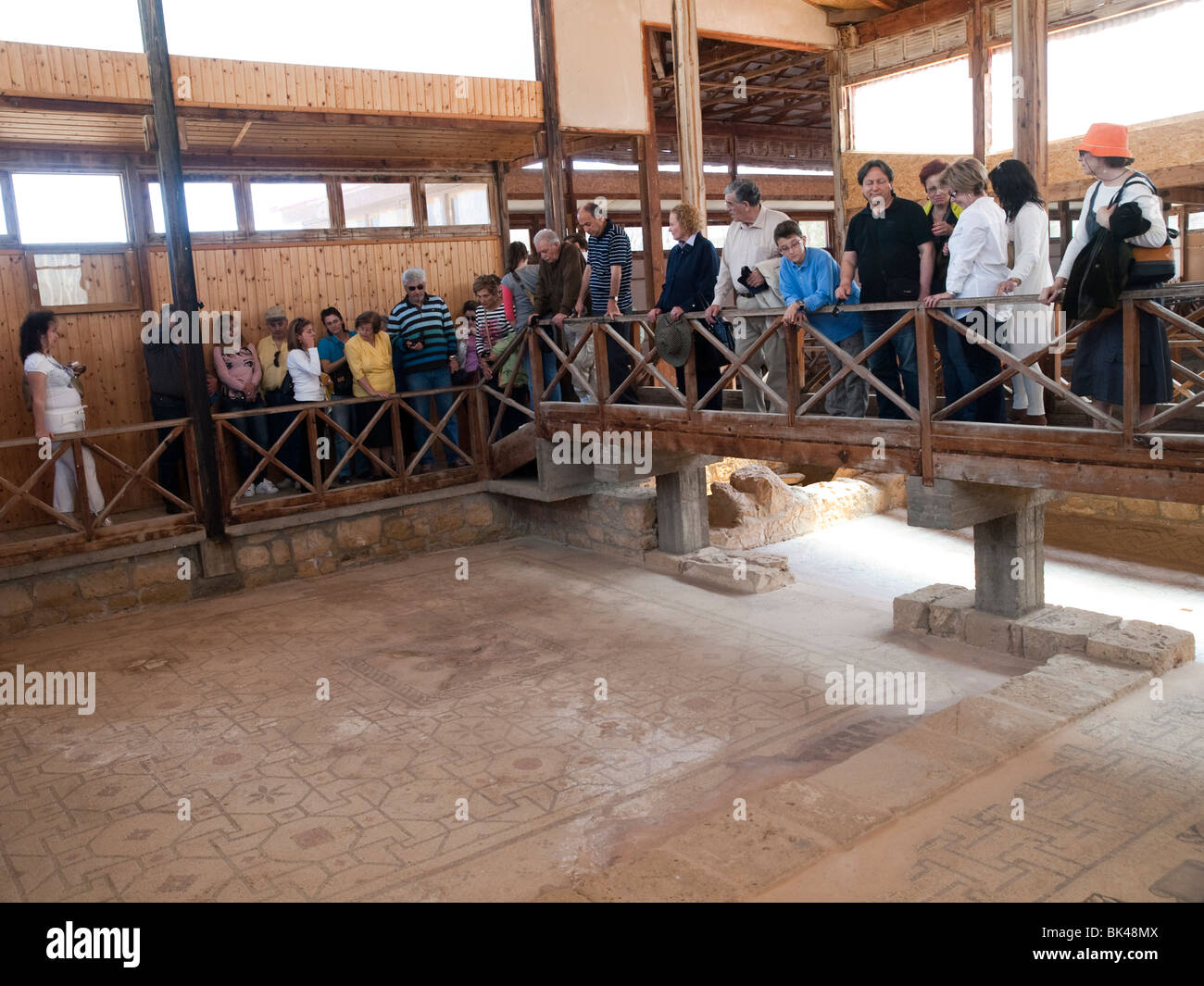 A tour group looking at the mosaics in the House of Dionysos at the ...