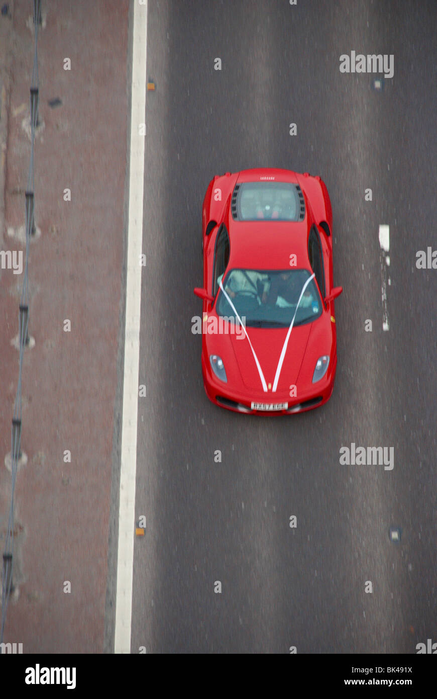 Red sports car (Ferrari?) with wedding ribbons on Stock Photo - Alamy