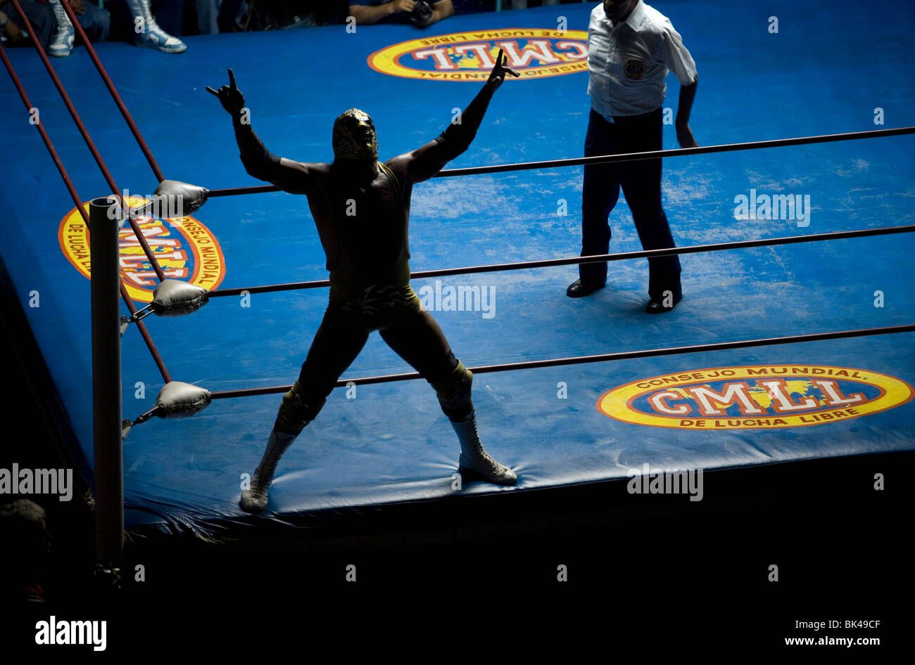 A wrestler celebrates a move during a Lucha Libre event in Puebla Arena ...