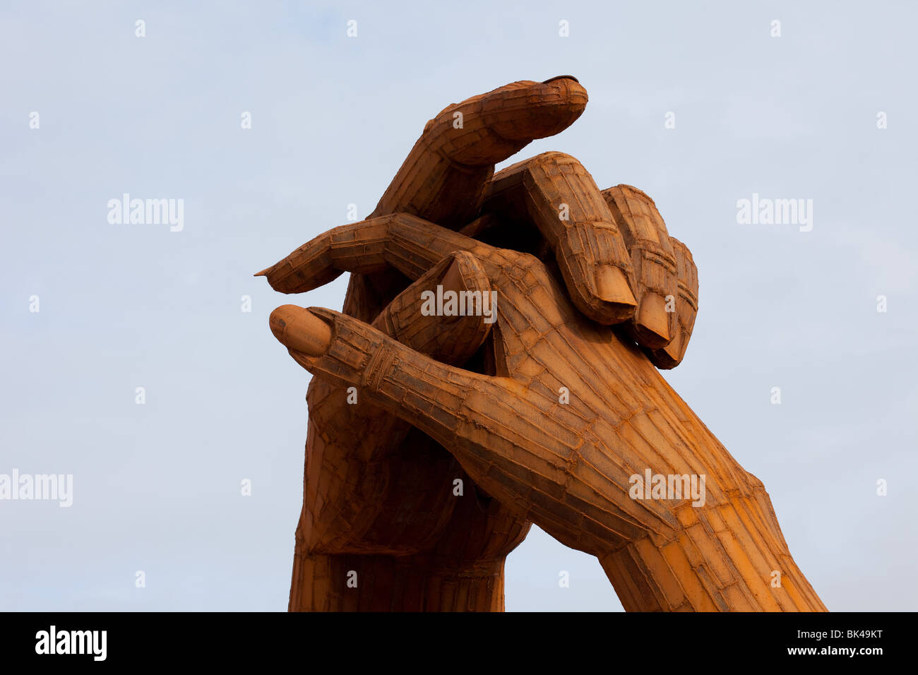 Metal Clasping hands, Pair of huge hands held in a loving clasp Ray ...