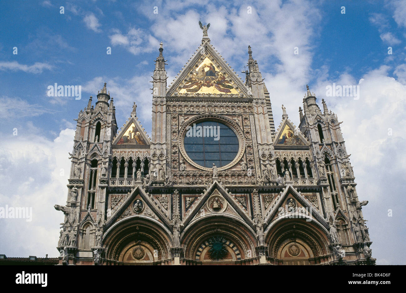 Detail showing the gables and the rose window of the Cathedral of Siena ...