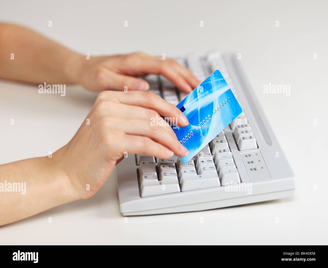 Hands with a plastic credit card on the computer keyboard Stock Photo ...