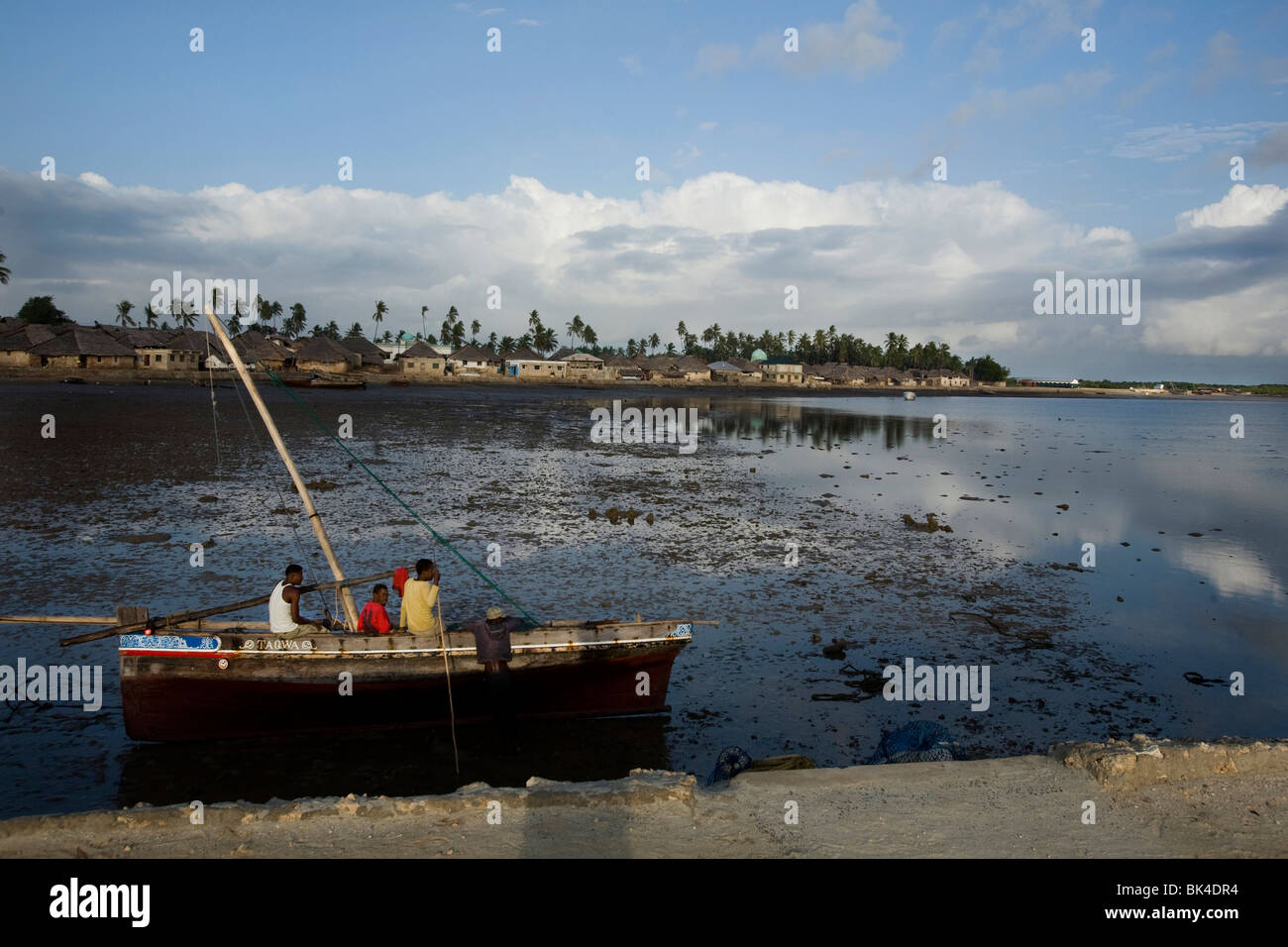 A sailing dhow on a low tide beach in the village of Kizingitini, Pate ...