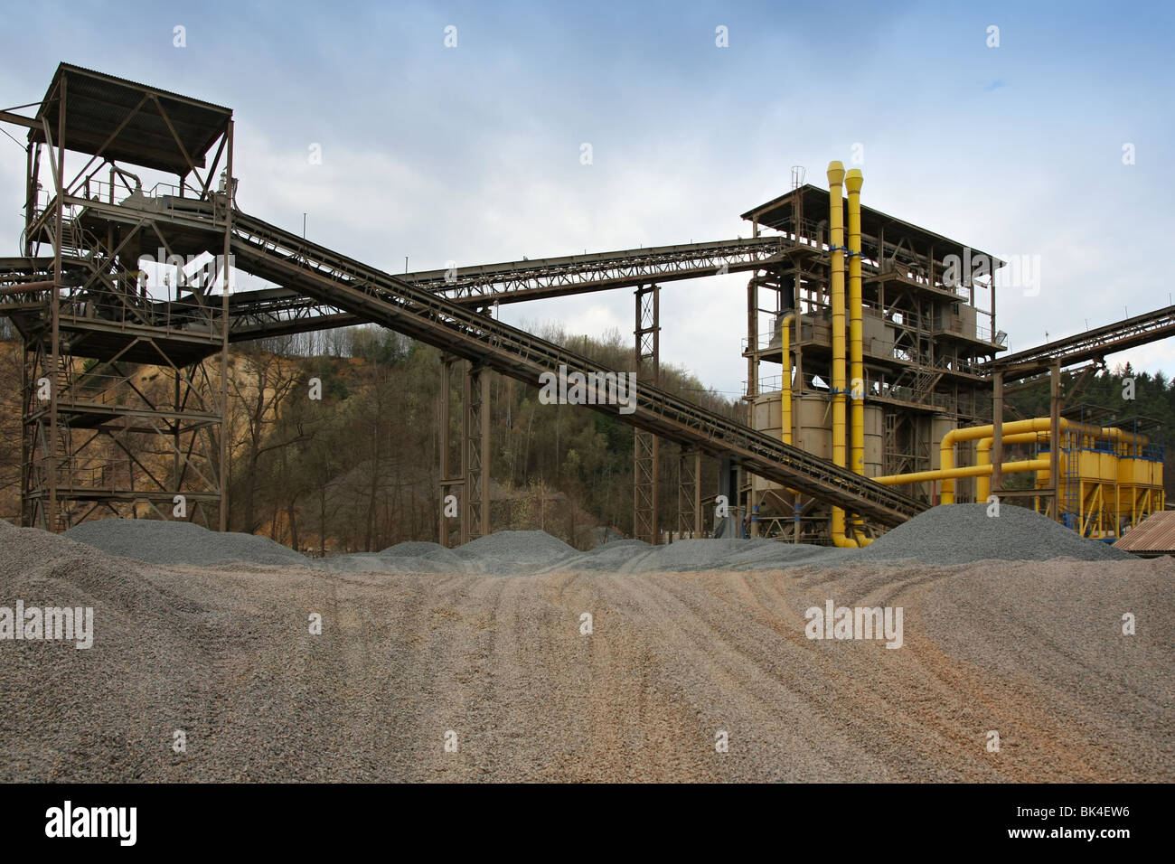 Stone quarry with silos, conveyor belts and piles of stones Stock Photo ...