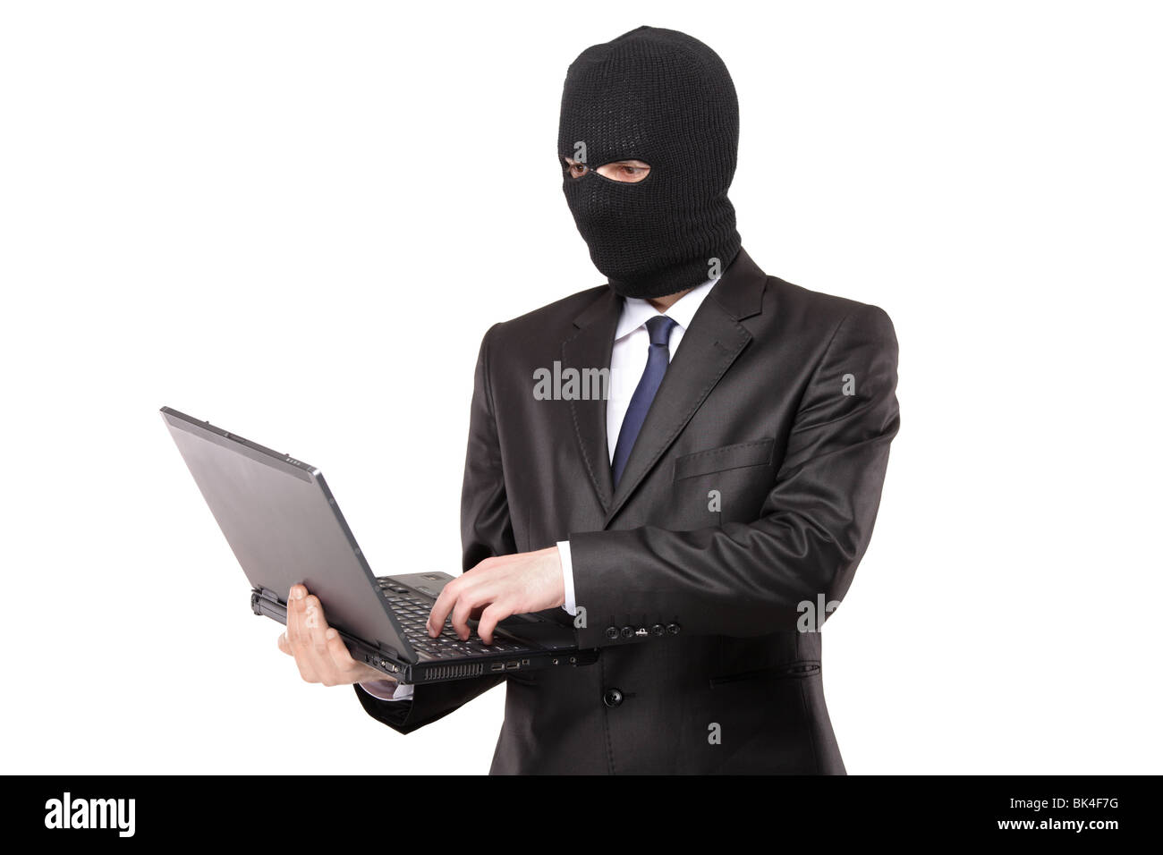 A hacker working on a laptop Stock Photo - Alamy