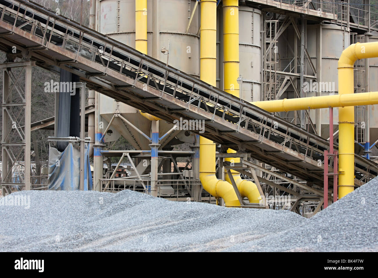 Stone quarry with silos, conveyor belts and piles of stones Stock Photo ...