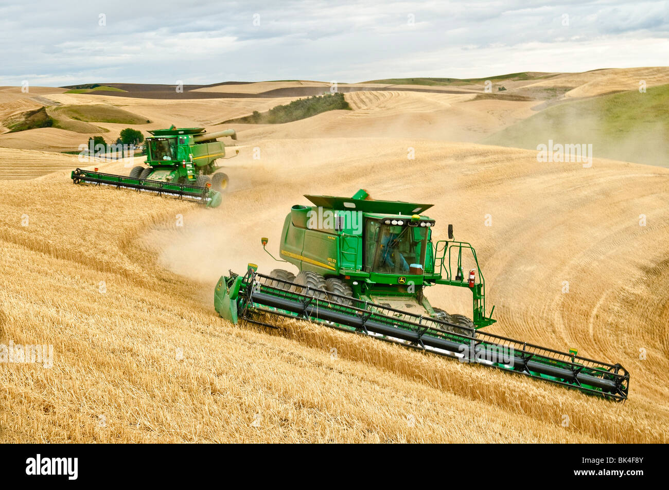 A pair of John Deere combines harvest soft white wheat in the Palouse ...