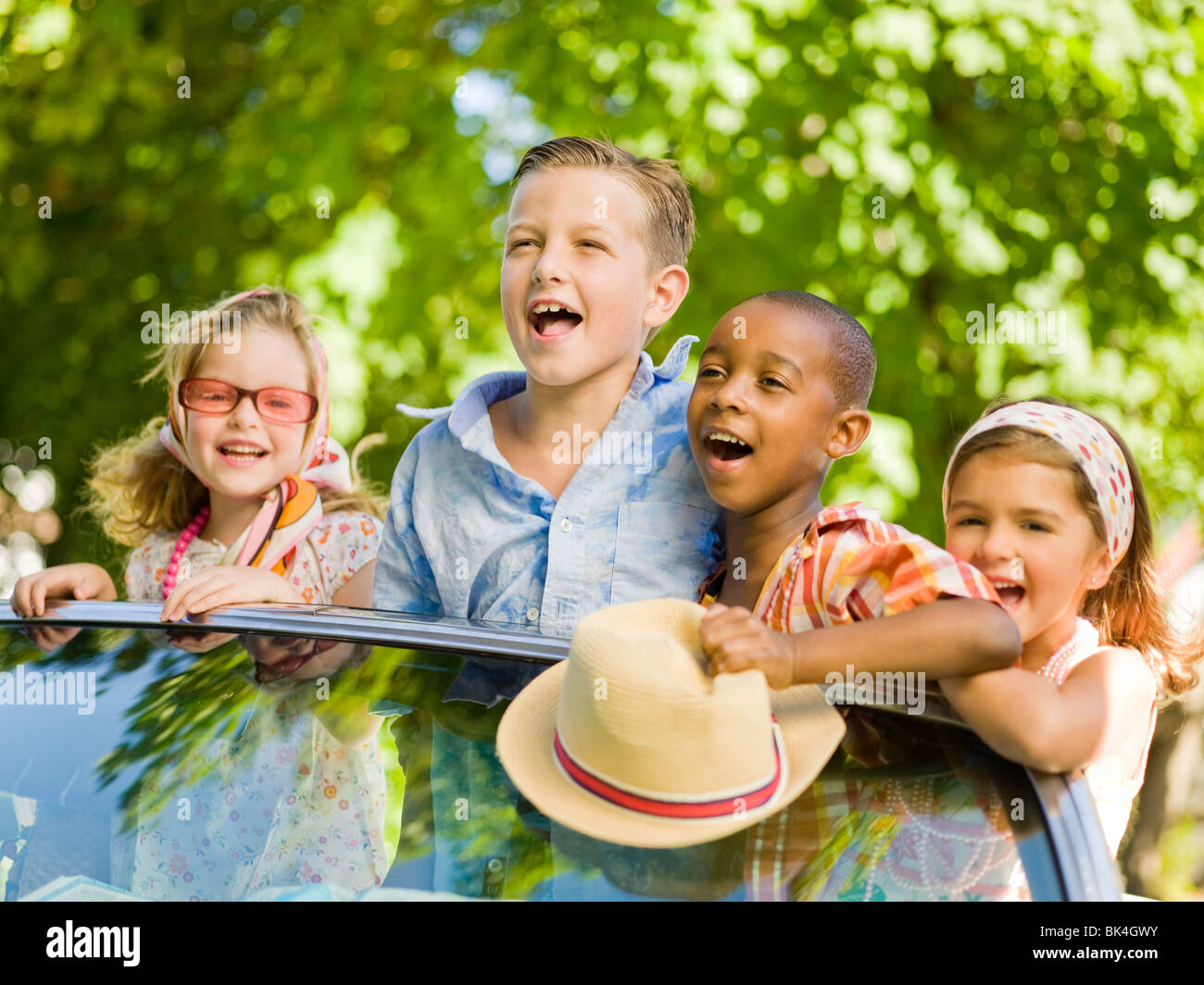 Kids hanging out of convertible Stock Photo - Alamy