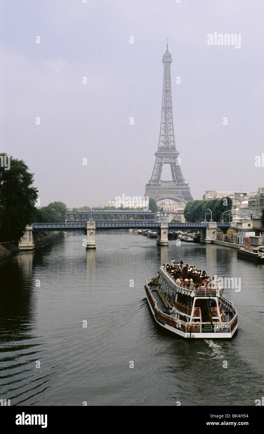 Tour boat on the Seine River with the Eiffel Tower in the background ...