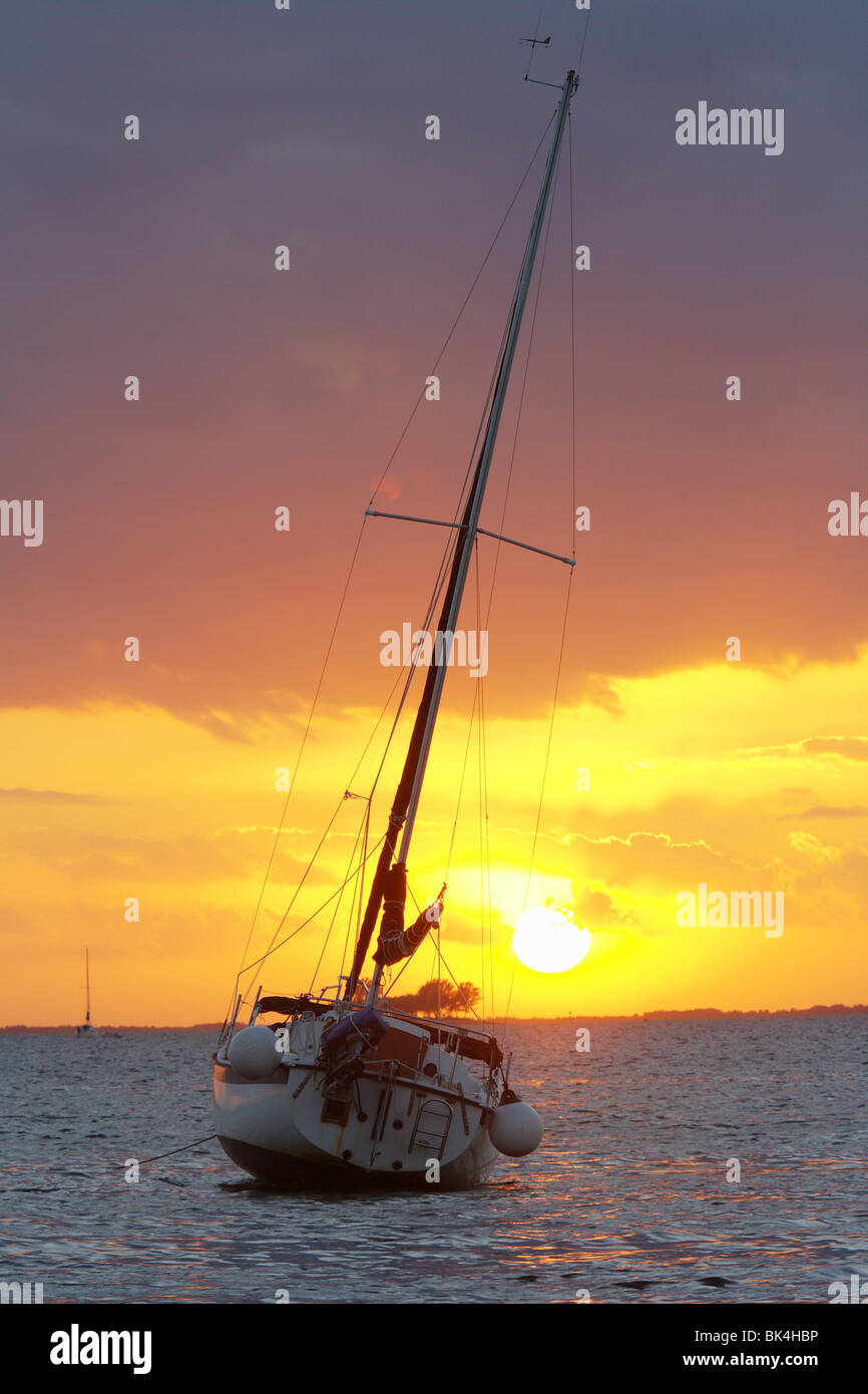 SAILBOAT DOCKED IN HARBOR AT SUNSET Stock Photo - Alamy