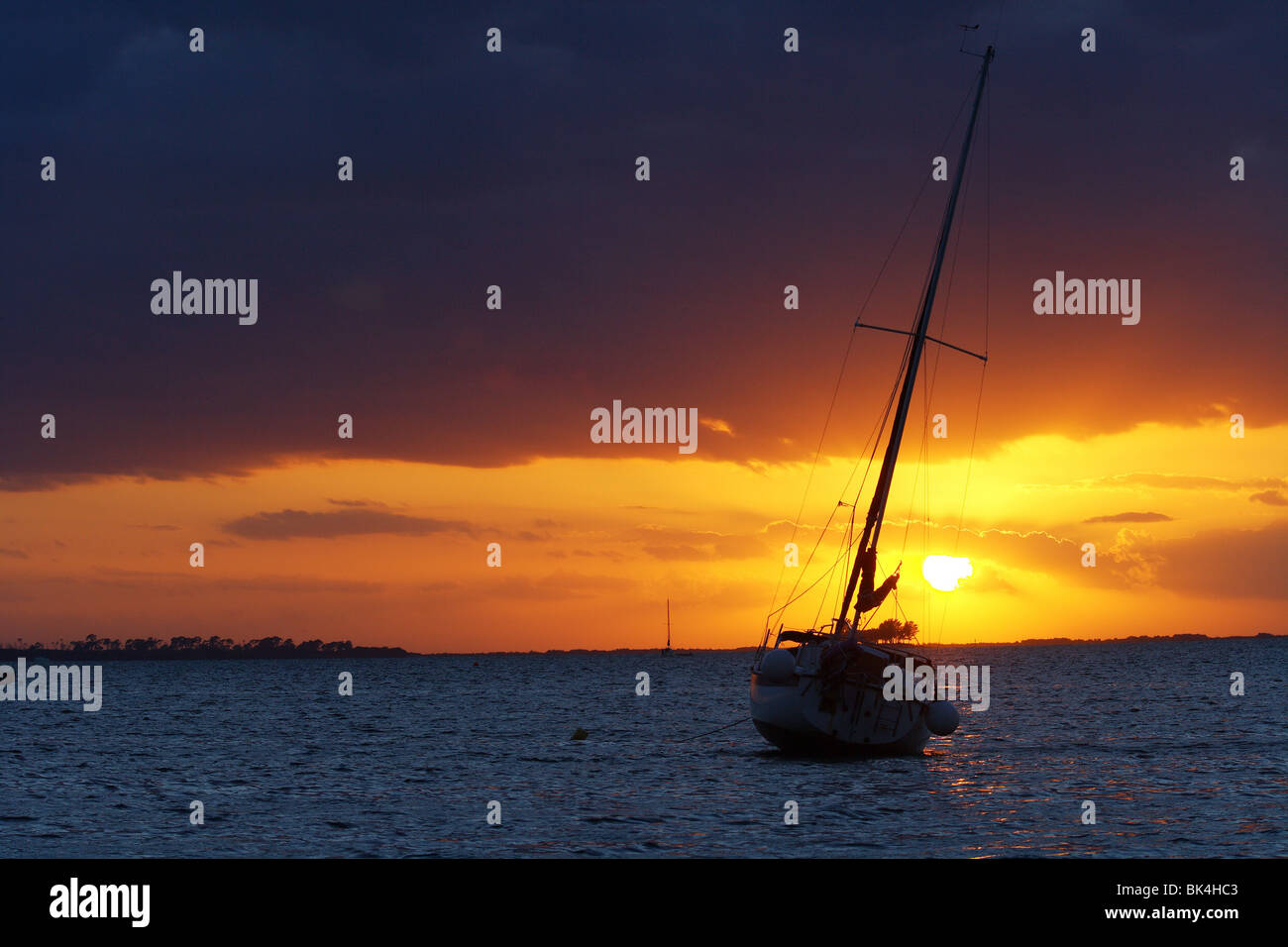 SAILBOAT DOCKED IN HARBOR AT SUNSET Stock Photo - Alamy
