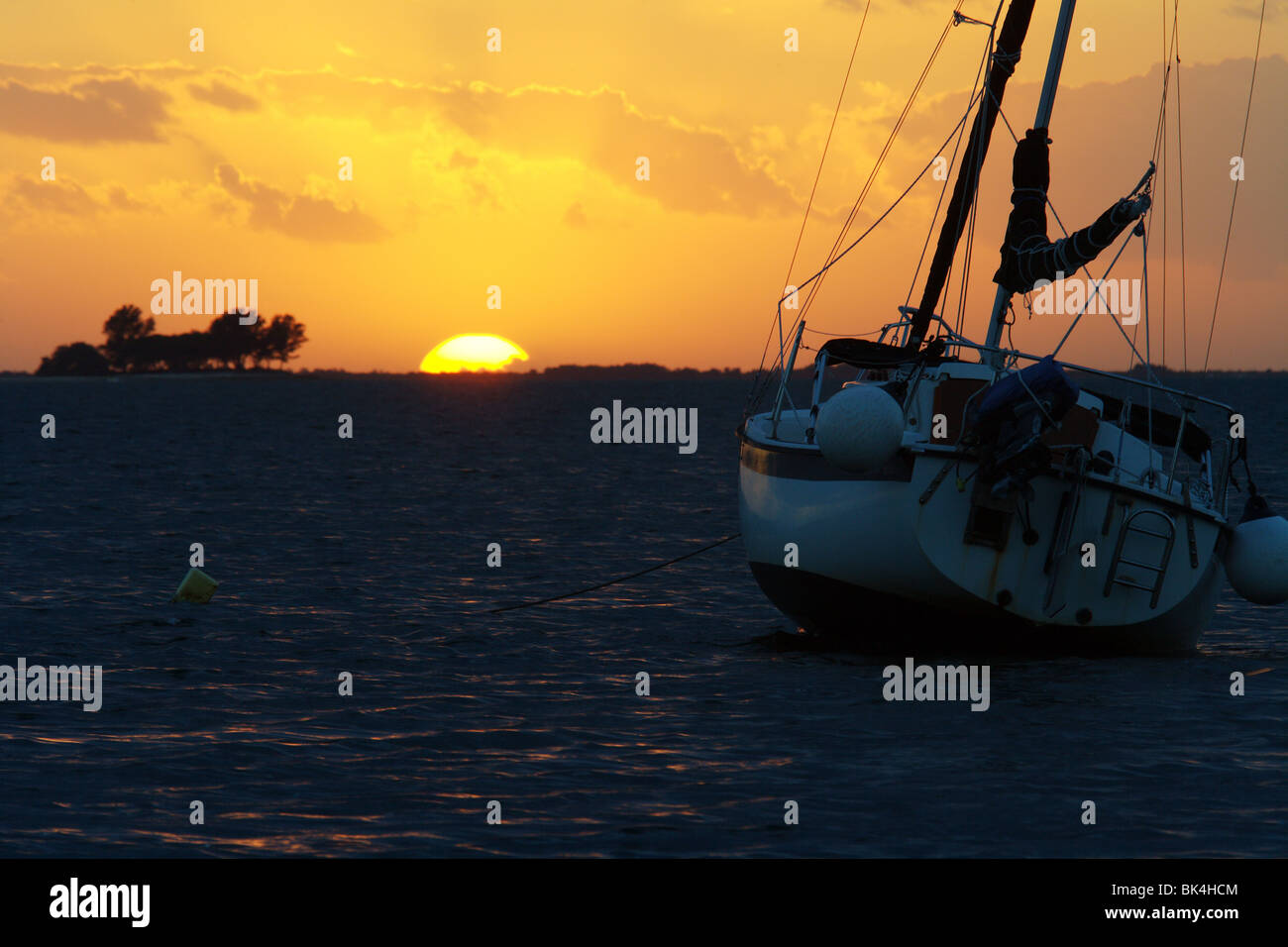 SAILBOAT DOCKED IN HARBOR AT SUNSET Stock Photo - Alamy