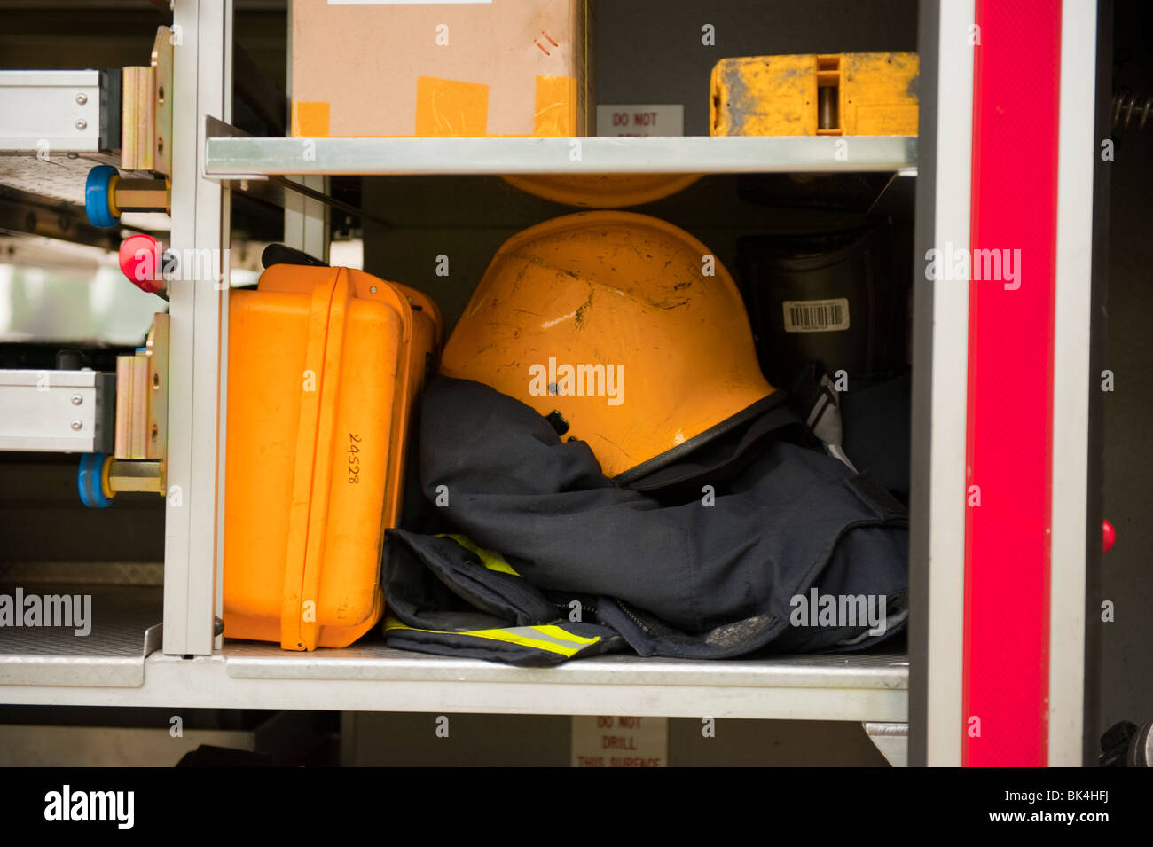 Firemans fire kit in locker on fire engine Stock Photo - Alamy