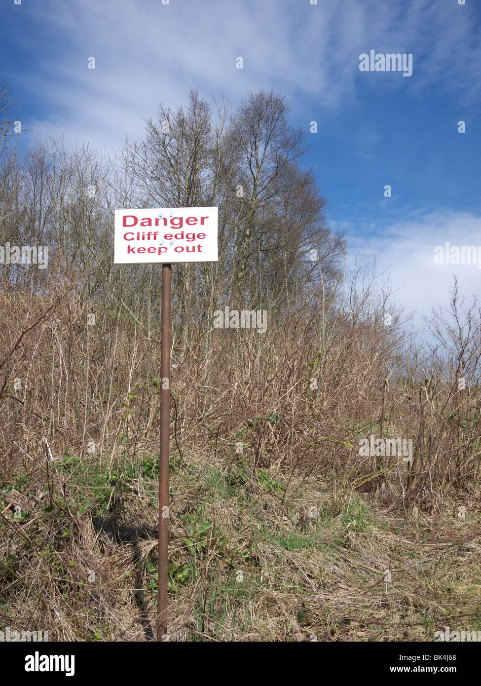 Danger sign near near cliff edge Stock Photo - Alamy