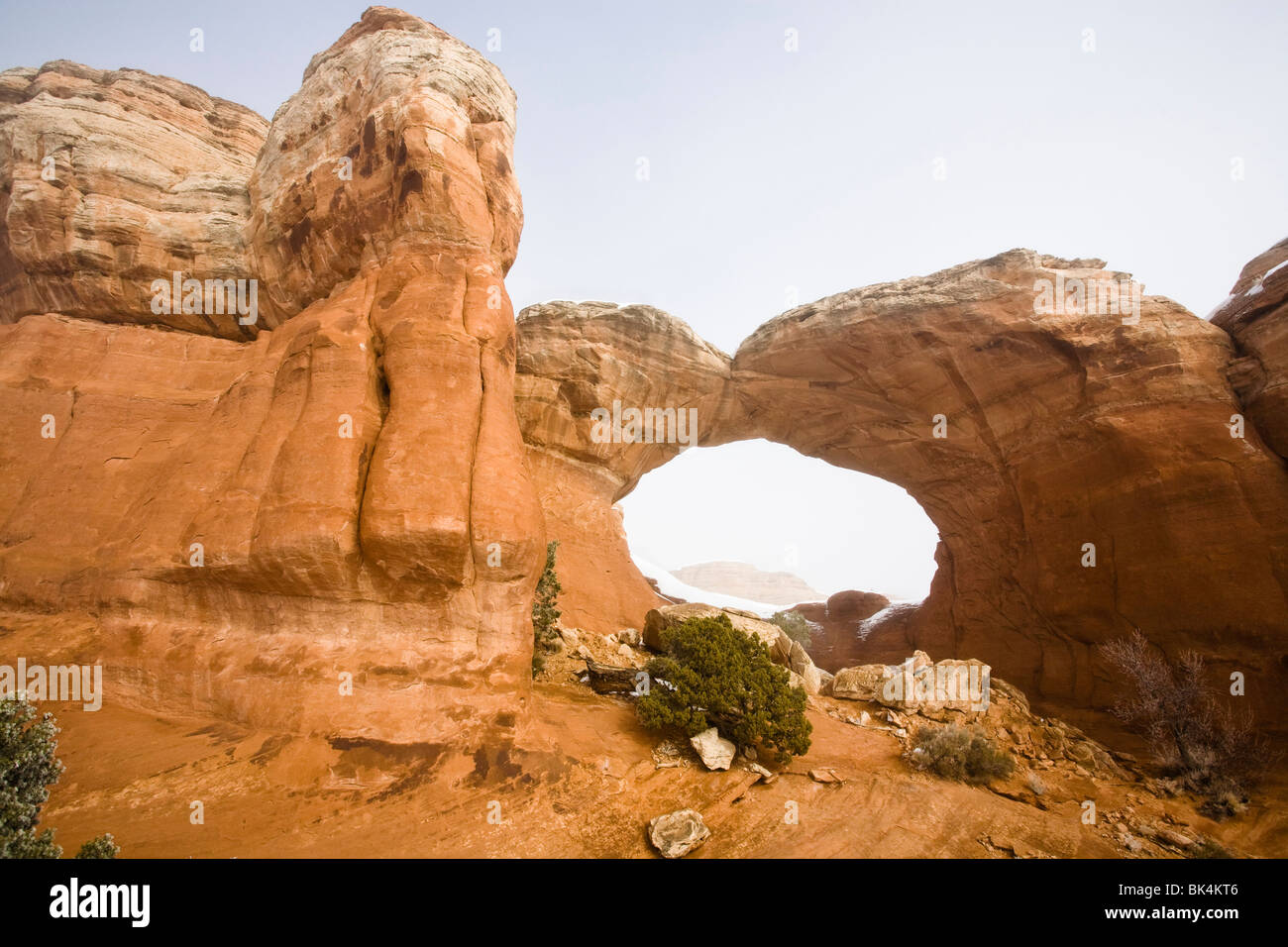 Broken Arch at Arches National Park, Utah. Snow and fog during winter ...
