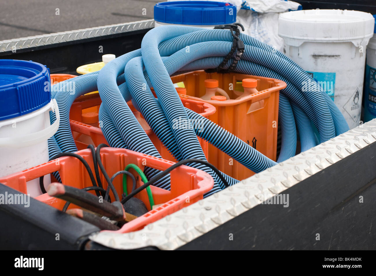 Swimming pool chemicals and cleaning equipment, in back of pickup truck ...
