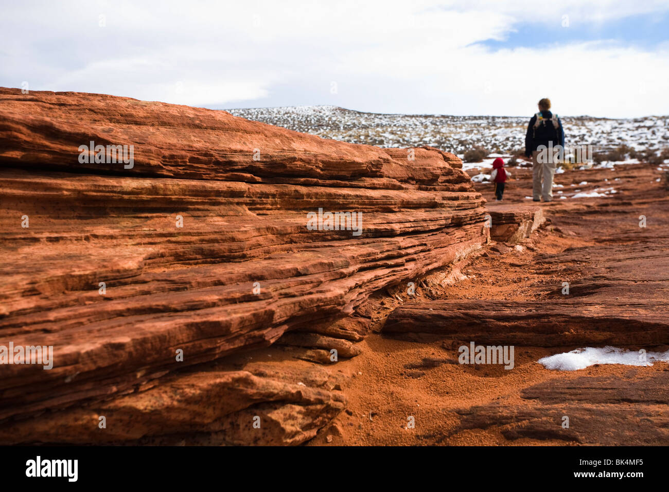 Red rock strata with mom and baby walking in the background Stock Photo ...