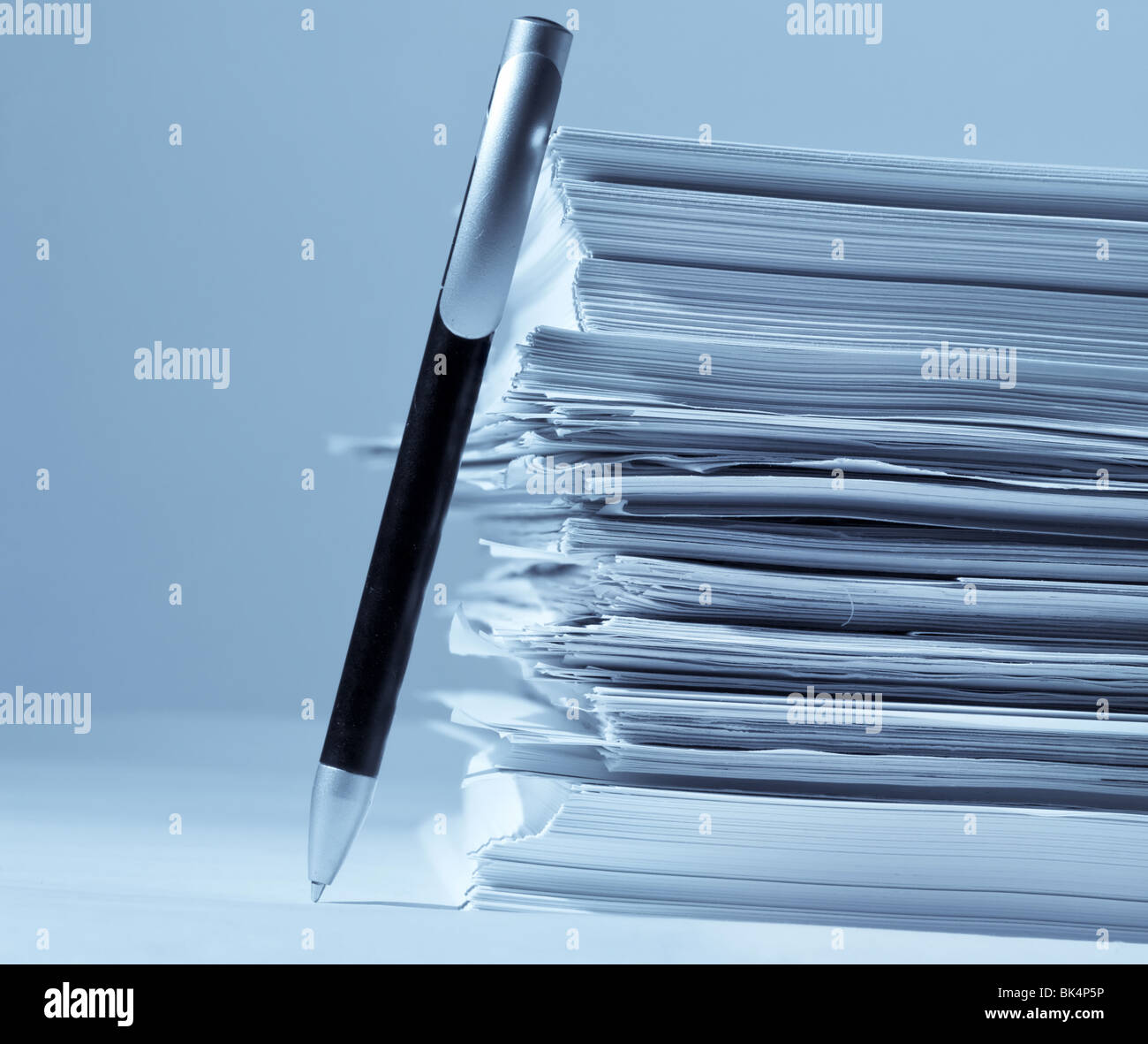 a pen near stack of paper Stock Photo - Alamy