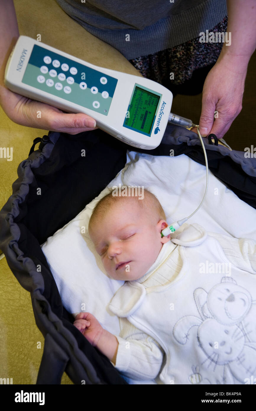 Newborn / new born baby undergoes a neonatal hearing screening test ...
