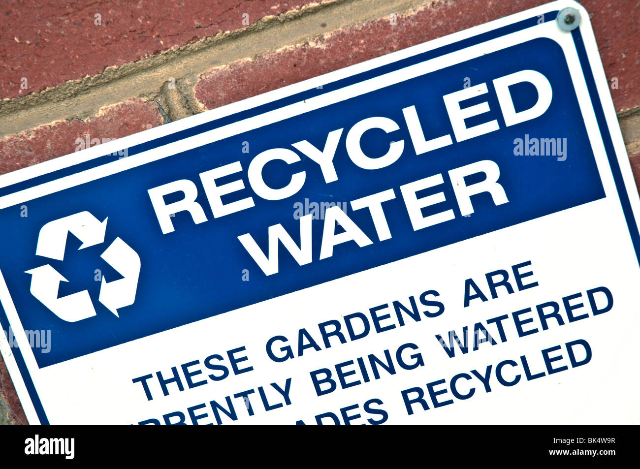 A sign outside a business using recycled water to water its public ...