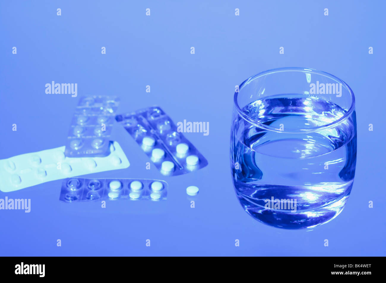 A glass of water and a variety of tablets. Isolated Stock Photo - Alamy