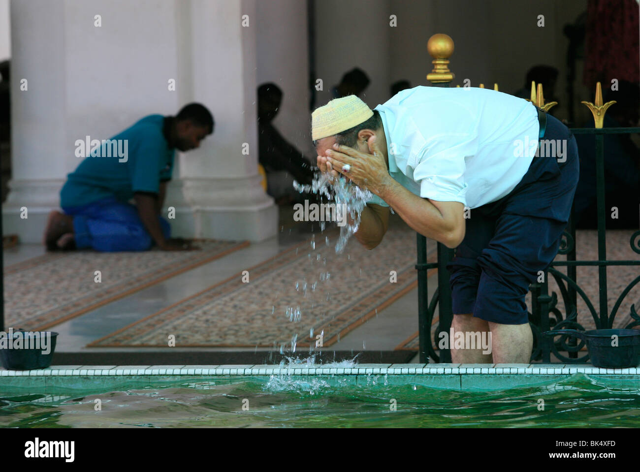 Man washing before prayers, Kapitan Kling Mosque, Penang, Malaysia ...
