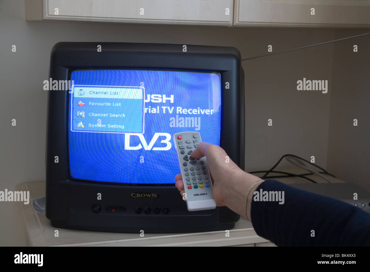 Close up Hand holding a remote control to start the Digital switchover ...