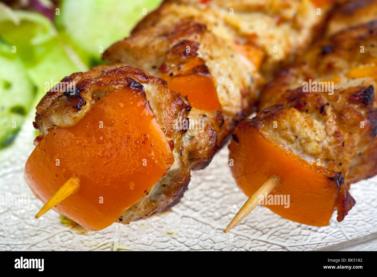two chicken shashlik on a glass plate Stock Photo - Alamy
