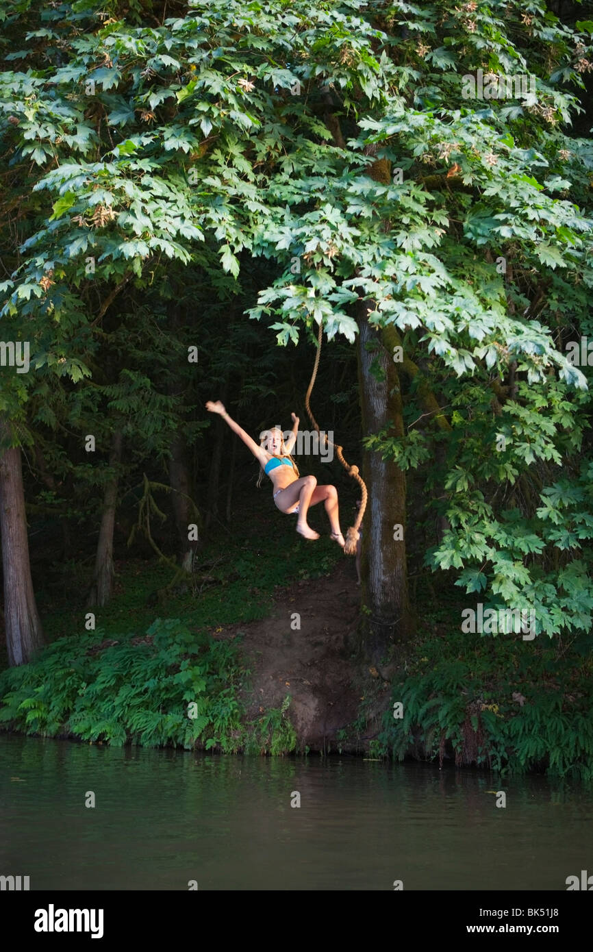 Teenage Girl Jumping Into Lake, Near Portland, Oregon, USA Stock Photo ...
