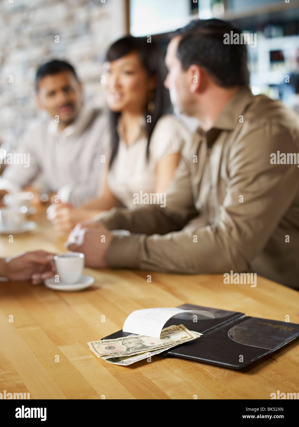 Friends at Restaurant Paying Bill Stock Photo - Alamy
