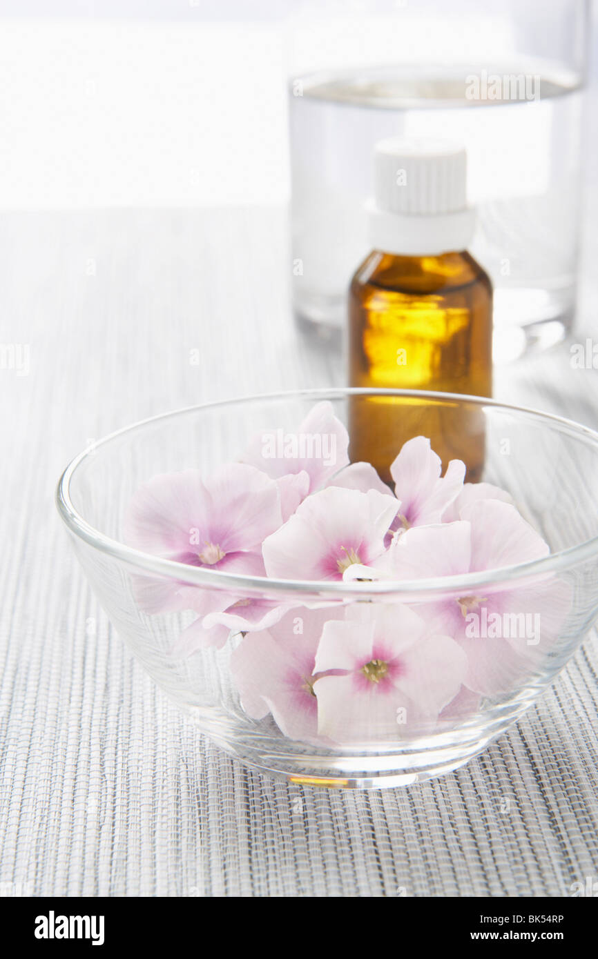 Flowers and Bottle of Oil Stock Photo - Alamy
